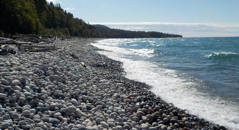 Pebble Beach, Ontario has colourful stones stretching the shoreline